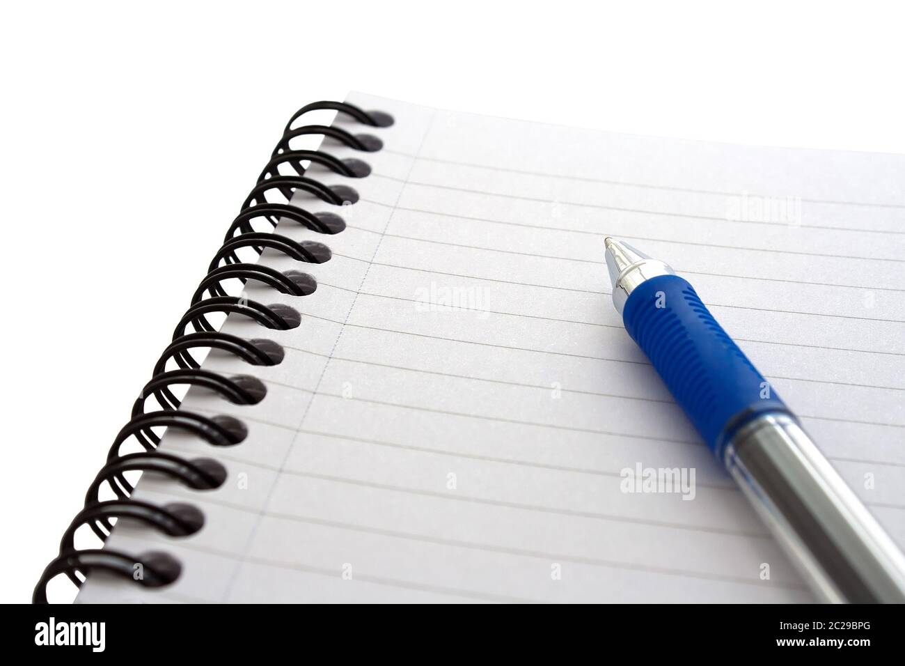 Notepad and pen on a isolated white background at an angle with medium ...