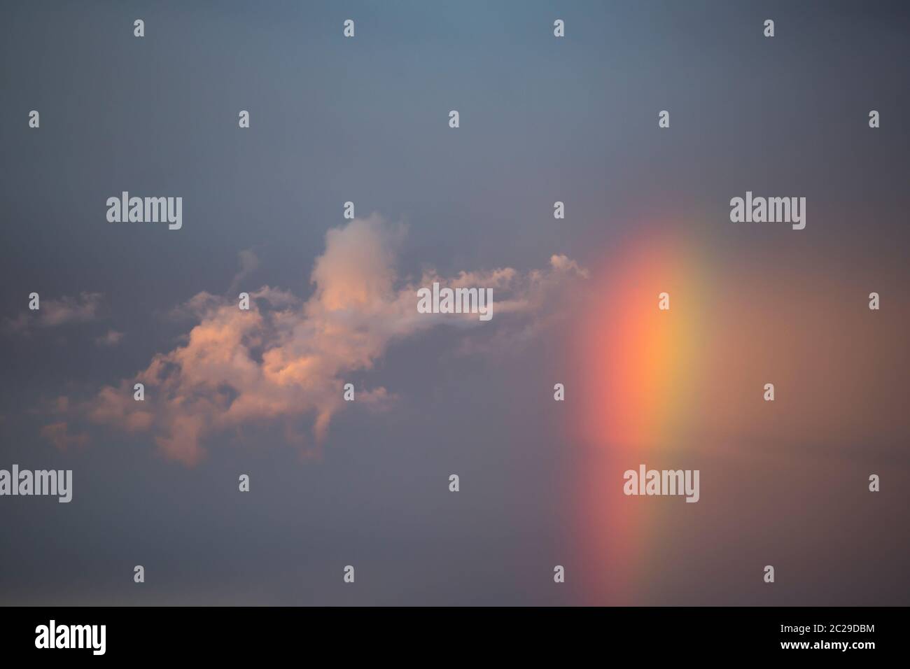 Rainbow and dramatic clouds in the sunset Stock Photo - Alamy