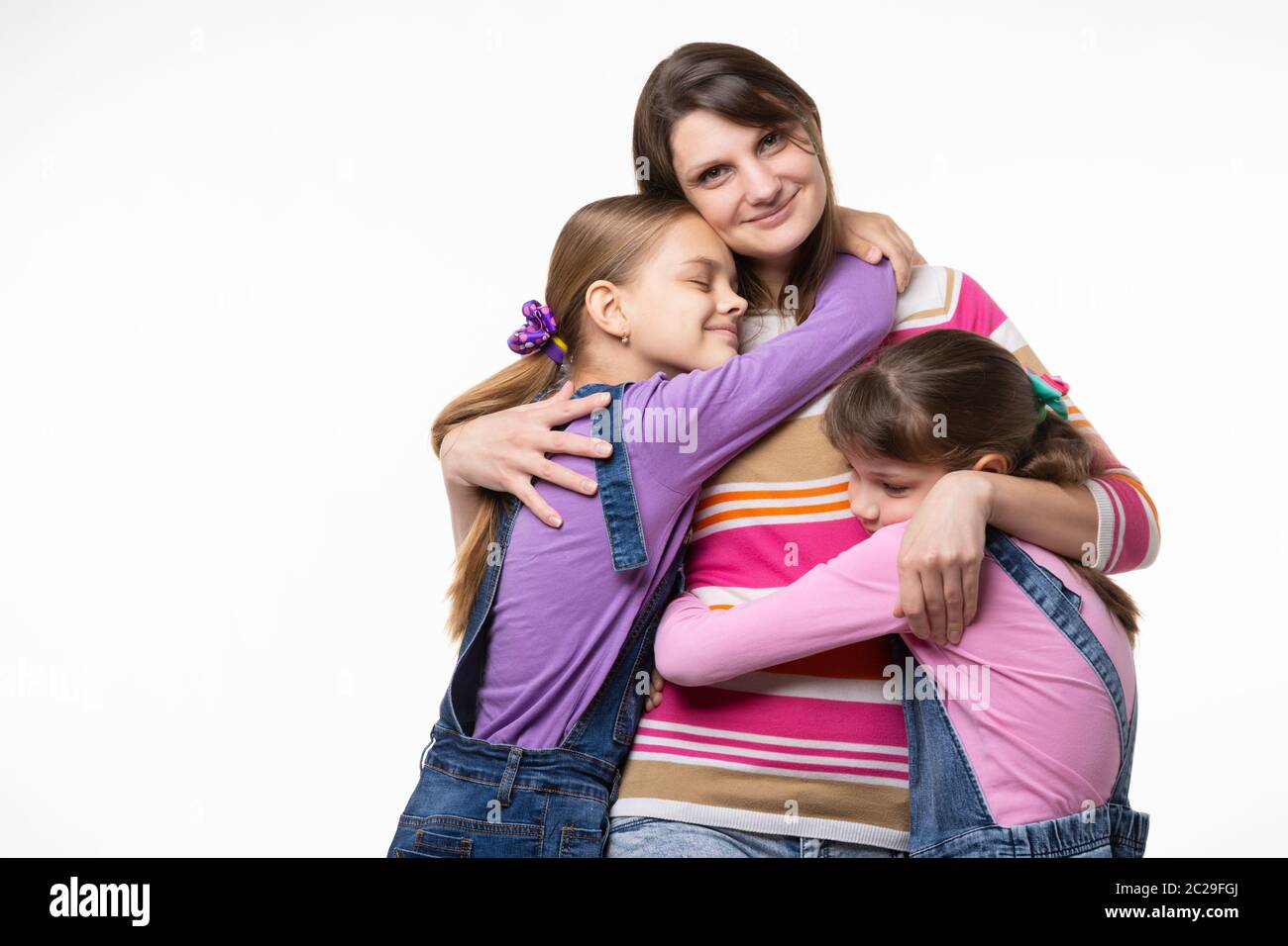 Children hug their beloved mom, mom happily looks in the frame Stock ...