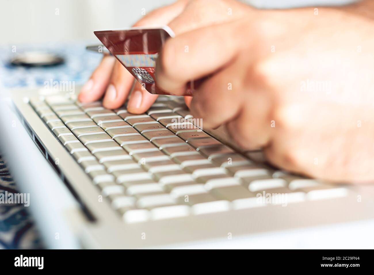 male person using a credit card for internet financial transactions ...