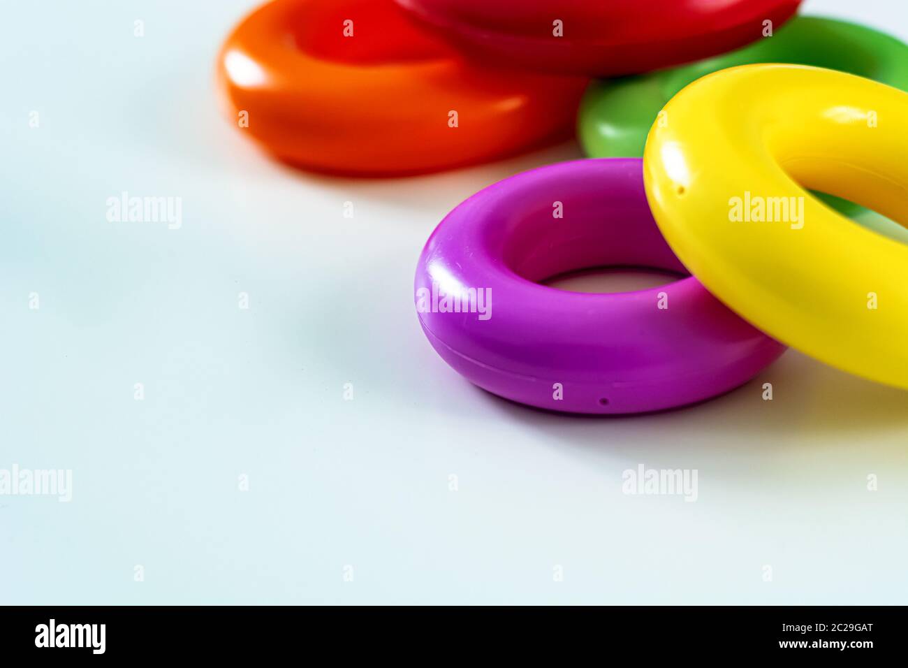 Colorful plastic rings on a white background to be stacked in a tower ...