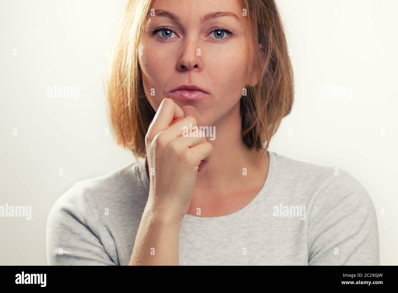 Woman with her hand on her cheek hi-res stock photography and images ...