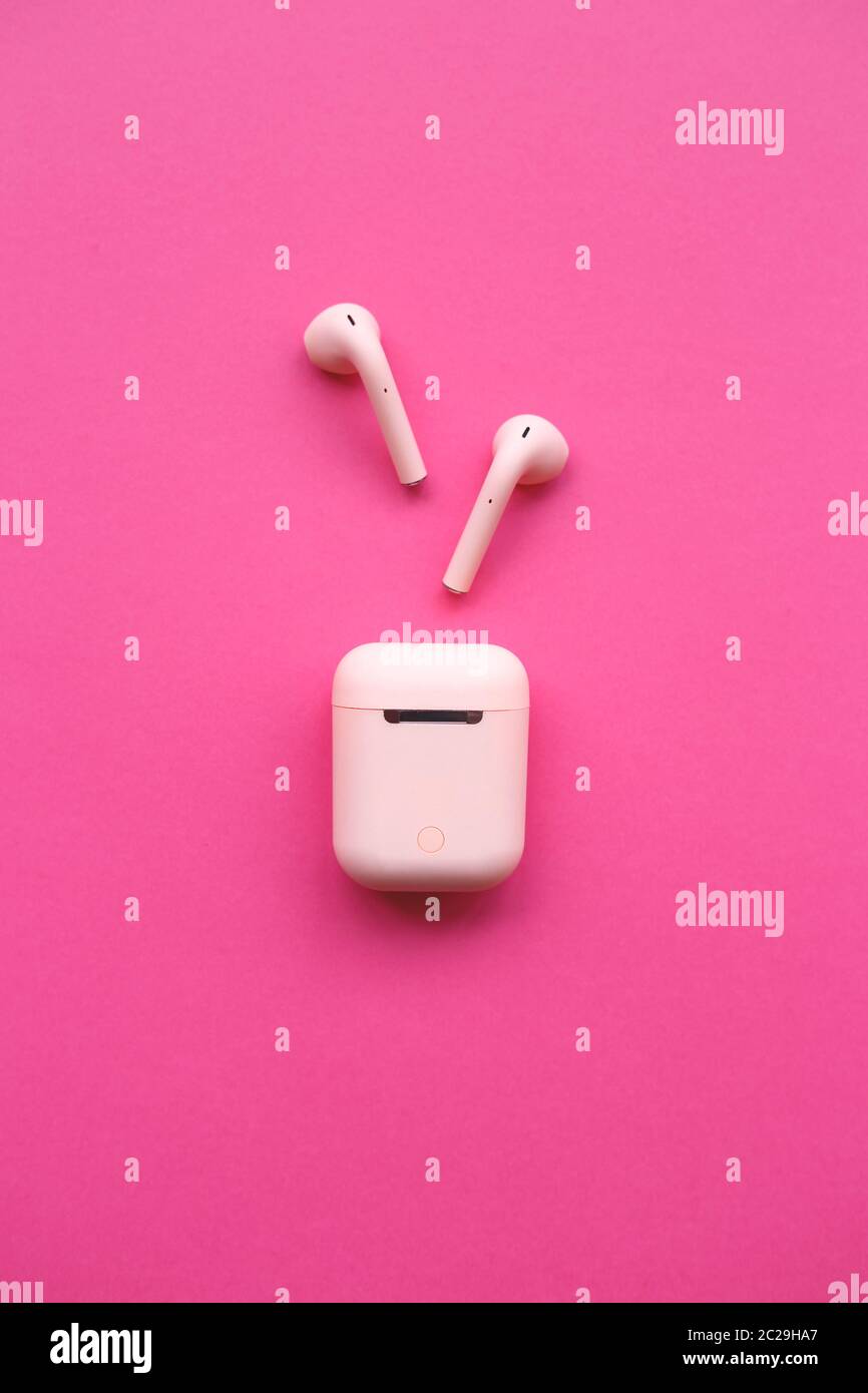 pink bluetooth headphones on a pink background Stock Photo - Alamy