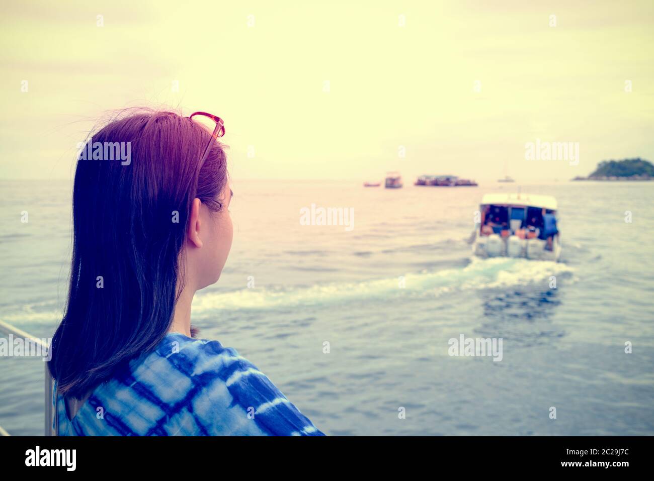 Woman looking at the boat that sailed away from her in vintage style ...