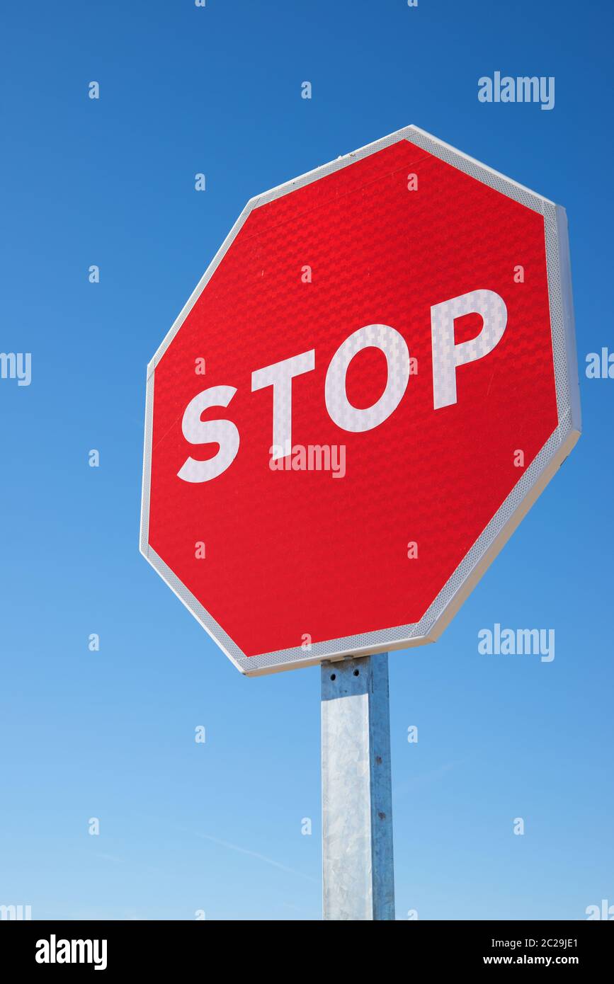 Stop traffic sign with clear blue sky Stock Photo - Alamy