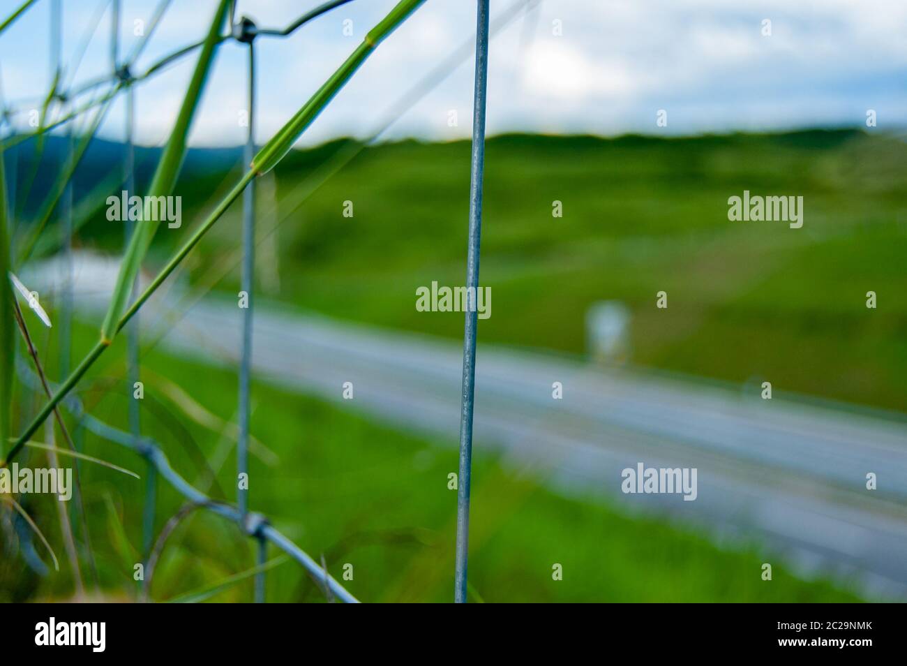 Fence on the side of the highway Stock Photo - Alamy