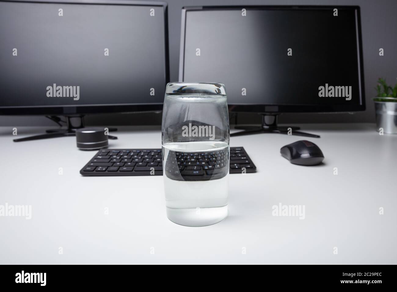 Glass Of Pure Water With Computer Desktop On White Desk Stock Photo - Alamy