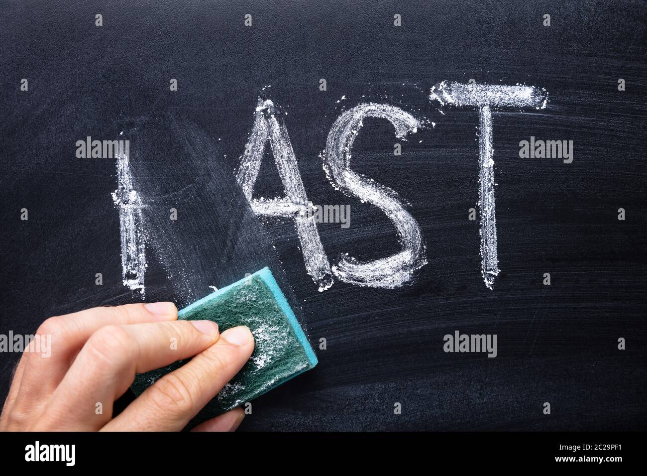 Hand Erasing Handwritten Word Past From Blackboard Stock Photo - Alamy