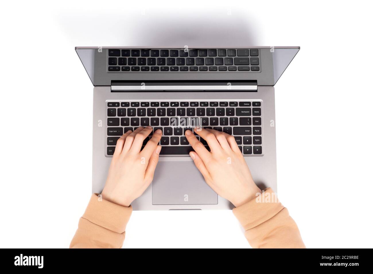 Person working on a laptop computer in a modern space. Female hands ...