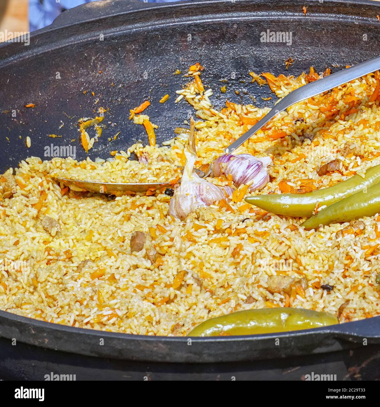 Traditional delicious pilaf with vegetables in a cauldron Stock Photo ...