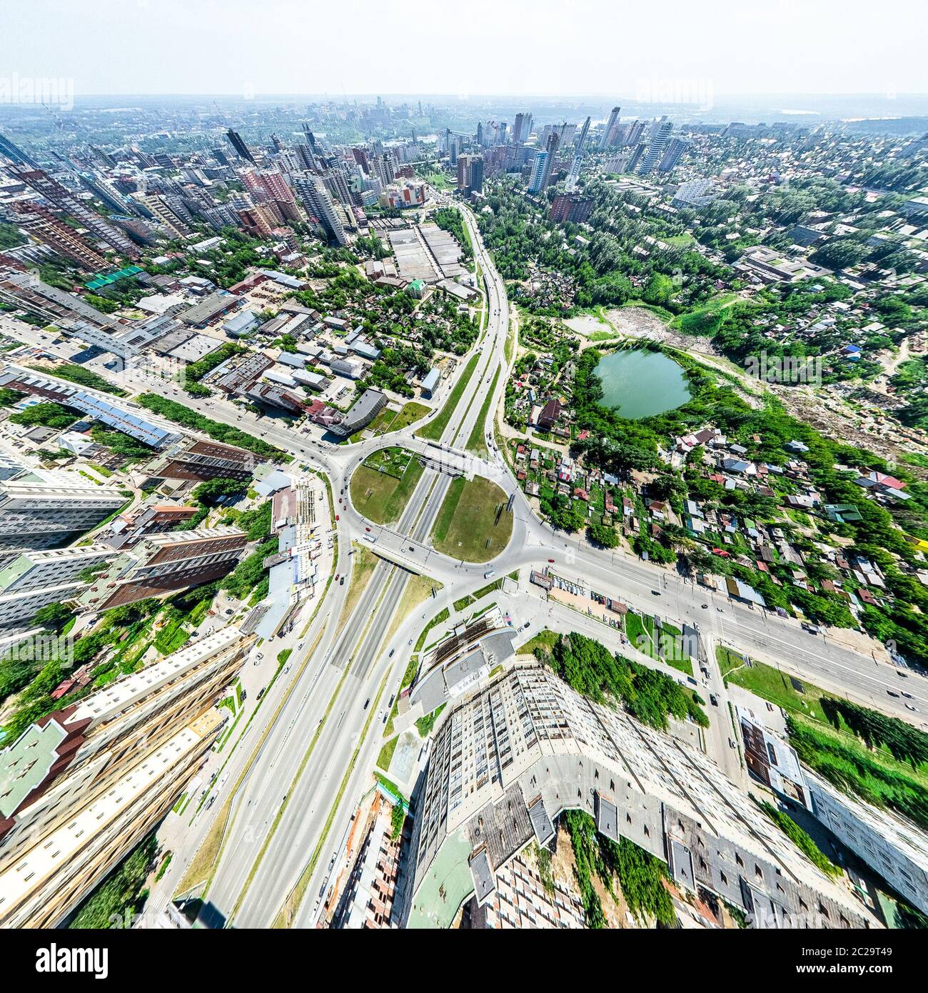 Aerial city view with crossroads and roads, houses, buildings, parks ...