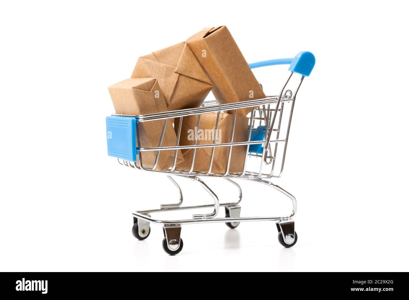 Online shopping concept. Shopping cart with small boxes inside on white ...