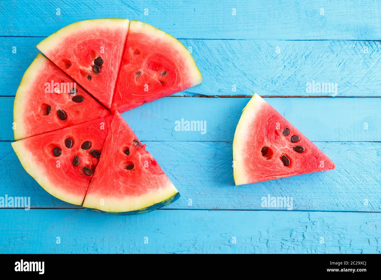 red scarlet watermelon pieces on blue wooden vintage background. summer ...