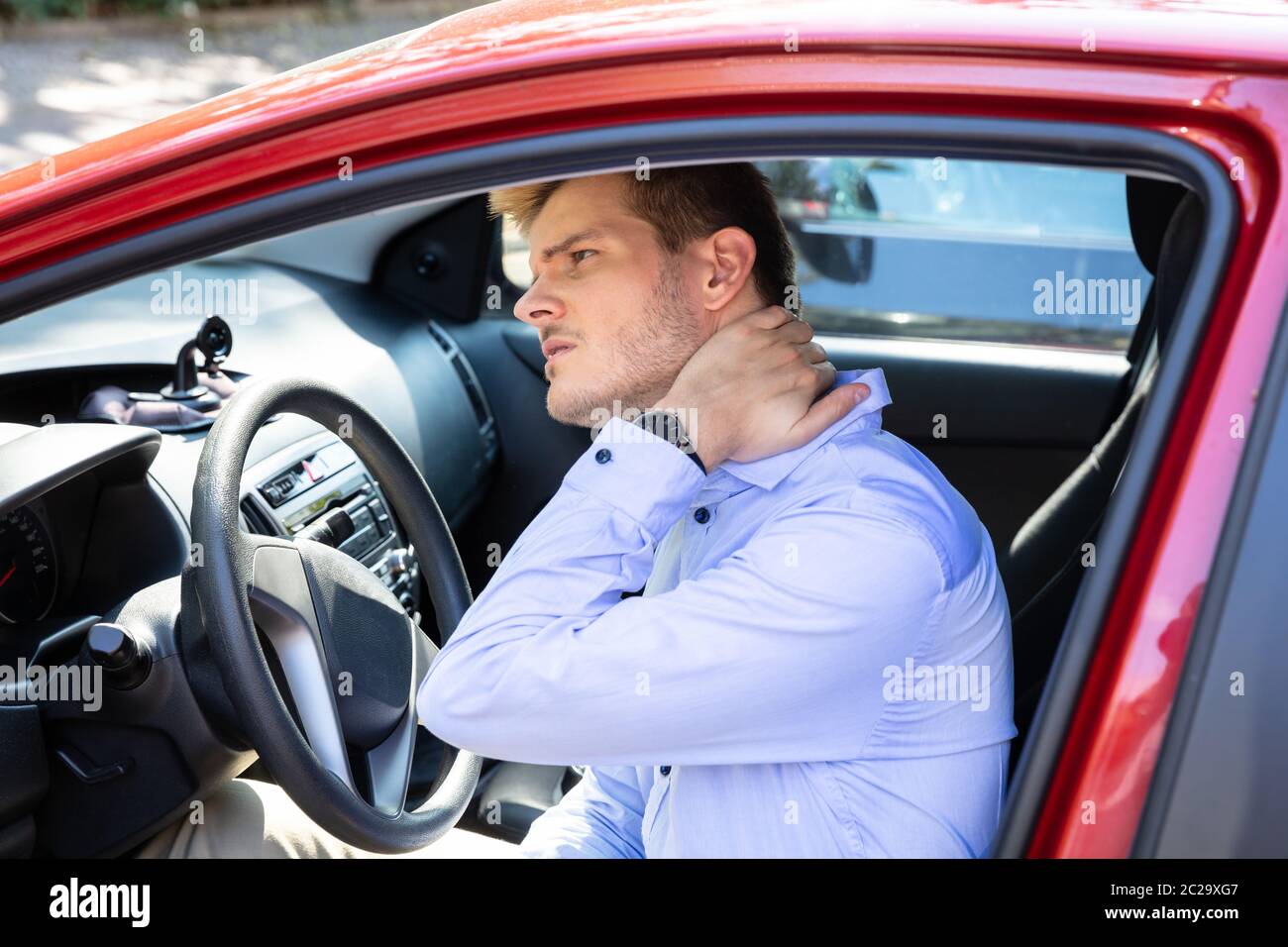 Driver Standing Having Neck Pain After Driving Car Stock Photo - Alamy