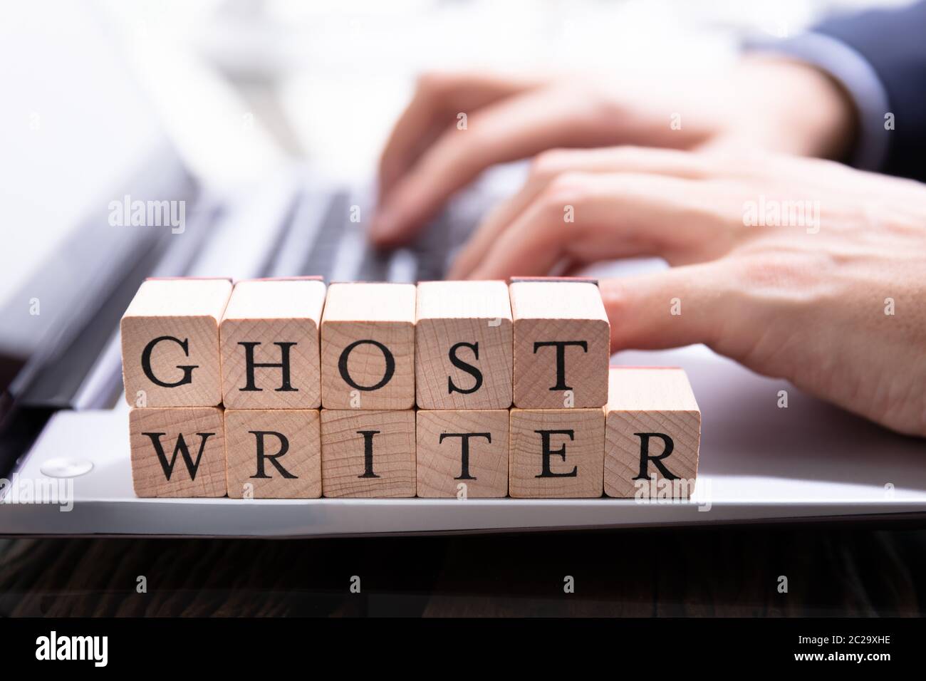Ghostwriter Wooden Block On Computer Keyboard While Someone Typing ...