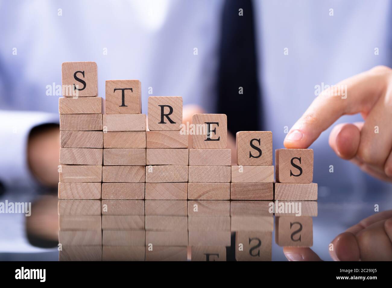 Reduce Stress Concept. Wooden Blocks In Declining Chart Stock Photo - Alamy