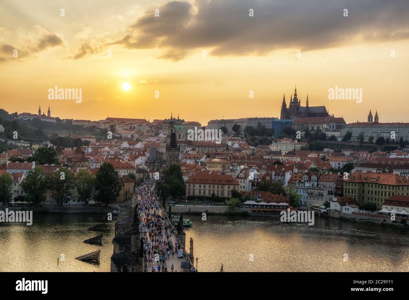sunset over the Charles bridge and prague castle viewed from the old ...