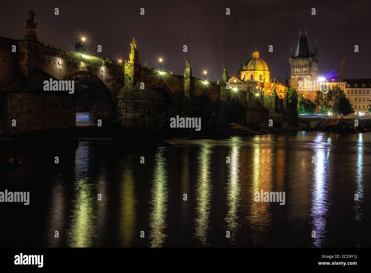 lesser town bridge tower and the charles bridge taken at night over the ...