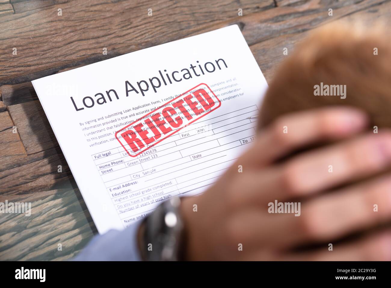 Stressed Person Looking At Rejected Loan Application Stock Photo - Alamy