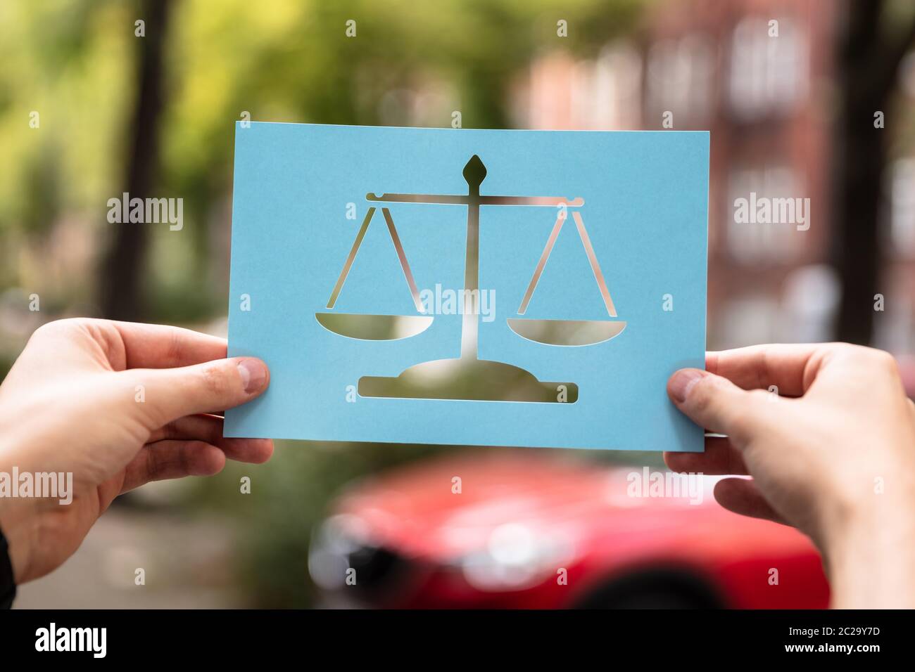 Hands Holding Paper With Cutout Law Scales Outdoors Stock Photo - Alamy