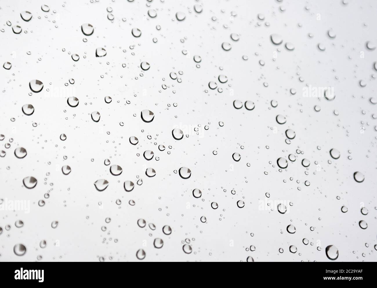 Drops of rain on the inclined window, shallow dof Stock Photo - Alamy