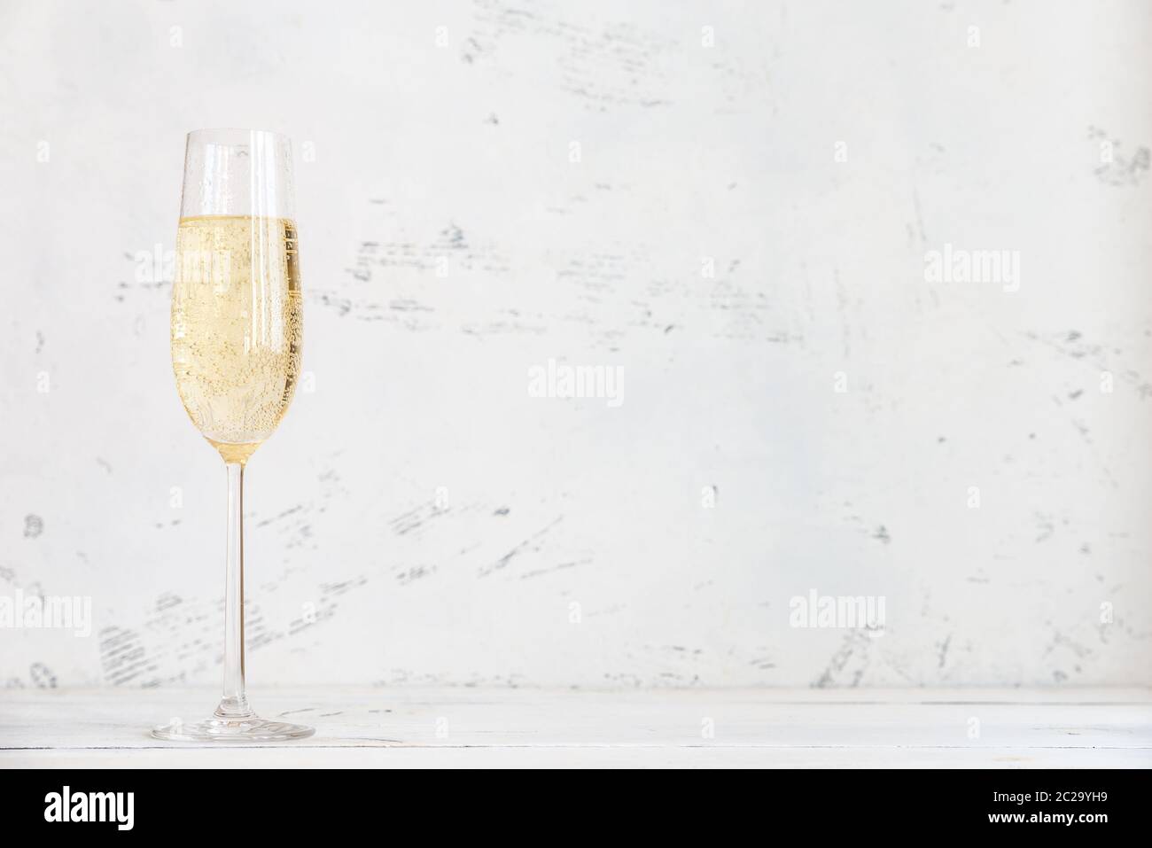 Glass of champagne on white background Stock Photo - Alamy