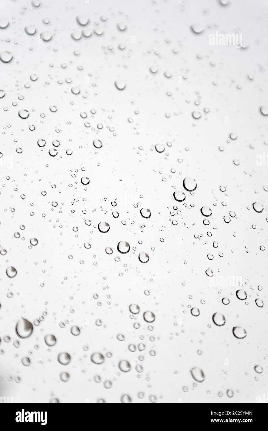 Drops of rain on the inclined window, shallow dof Stock Photo - Alamy