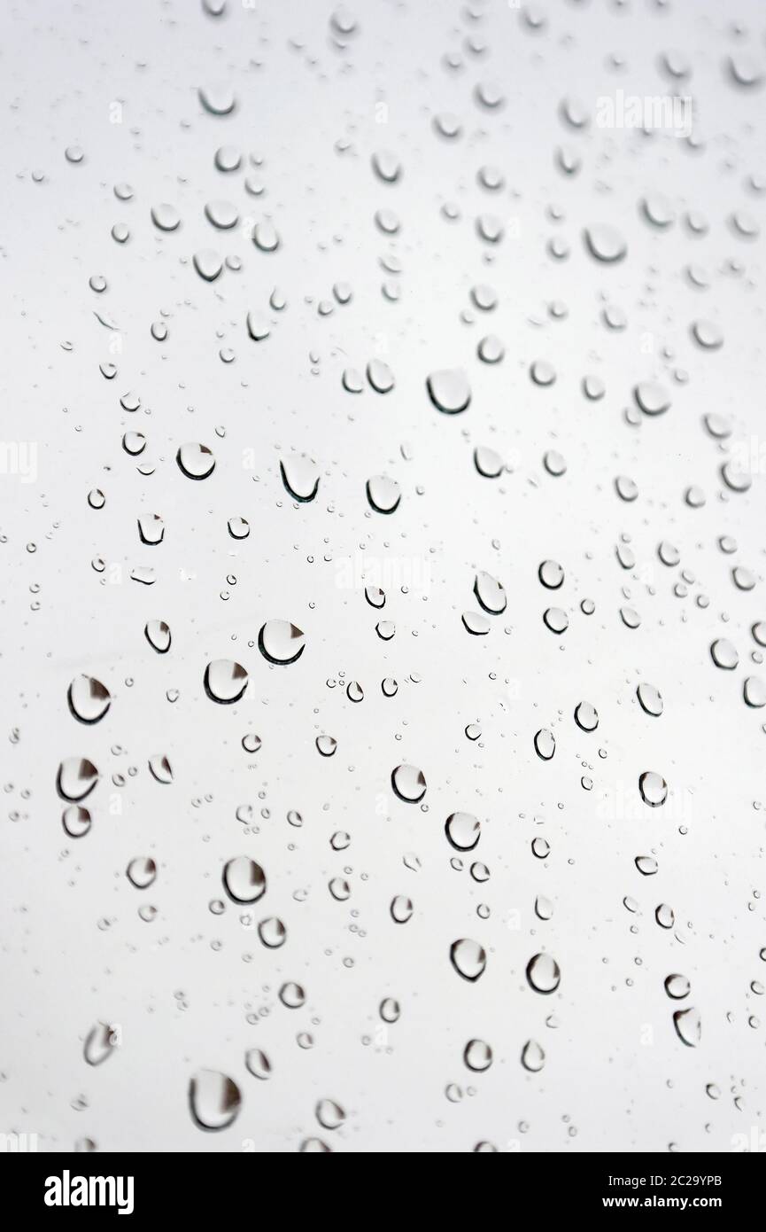 Drops of rain on the inclined window, shallow dof Stock Photo - Alamy