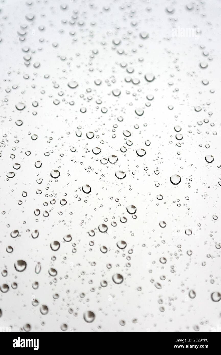 Drops of rain on the inclined window, shallow dof Stock Photo - Alamy
