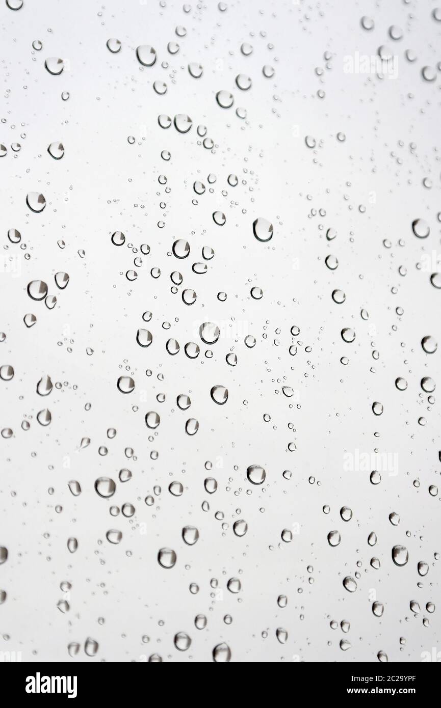 Drops of rain on the inclined window, shallow dof Stock Photo - Alamy