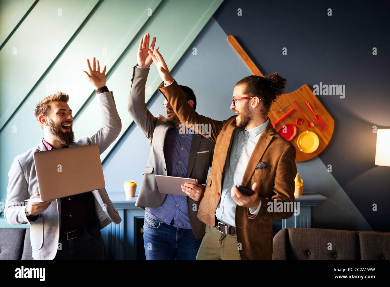 Happy successful business man giving a high fives gesture as cheer ...