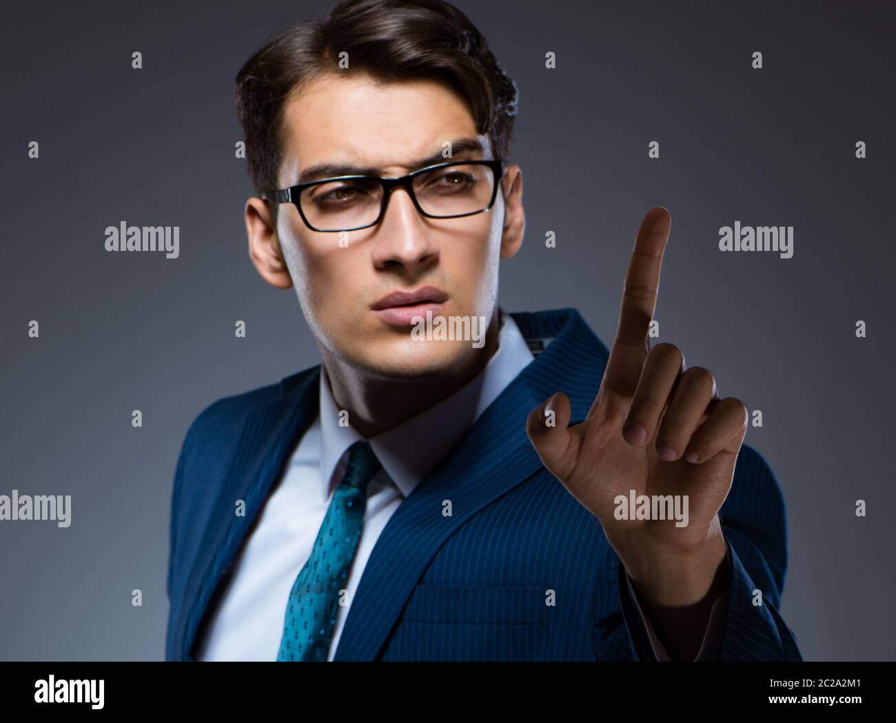 Businessman pressing virtual buttons on gray background Stock Photo - Alamy