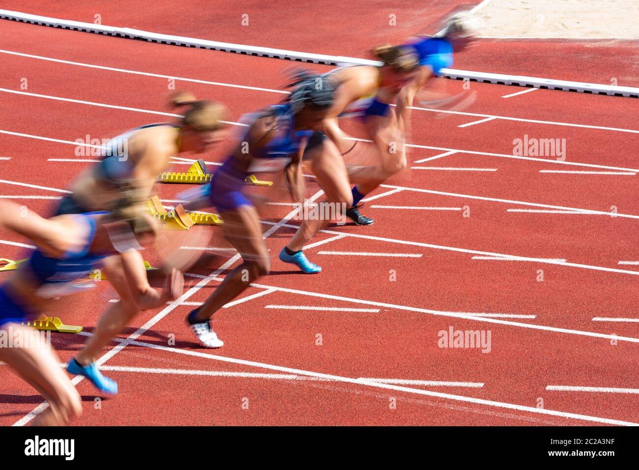 100 m sprint of the ladies in stadium in blurred style Stock Photo - Alamy