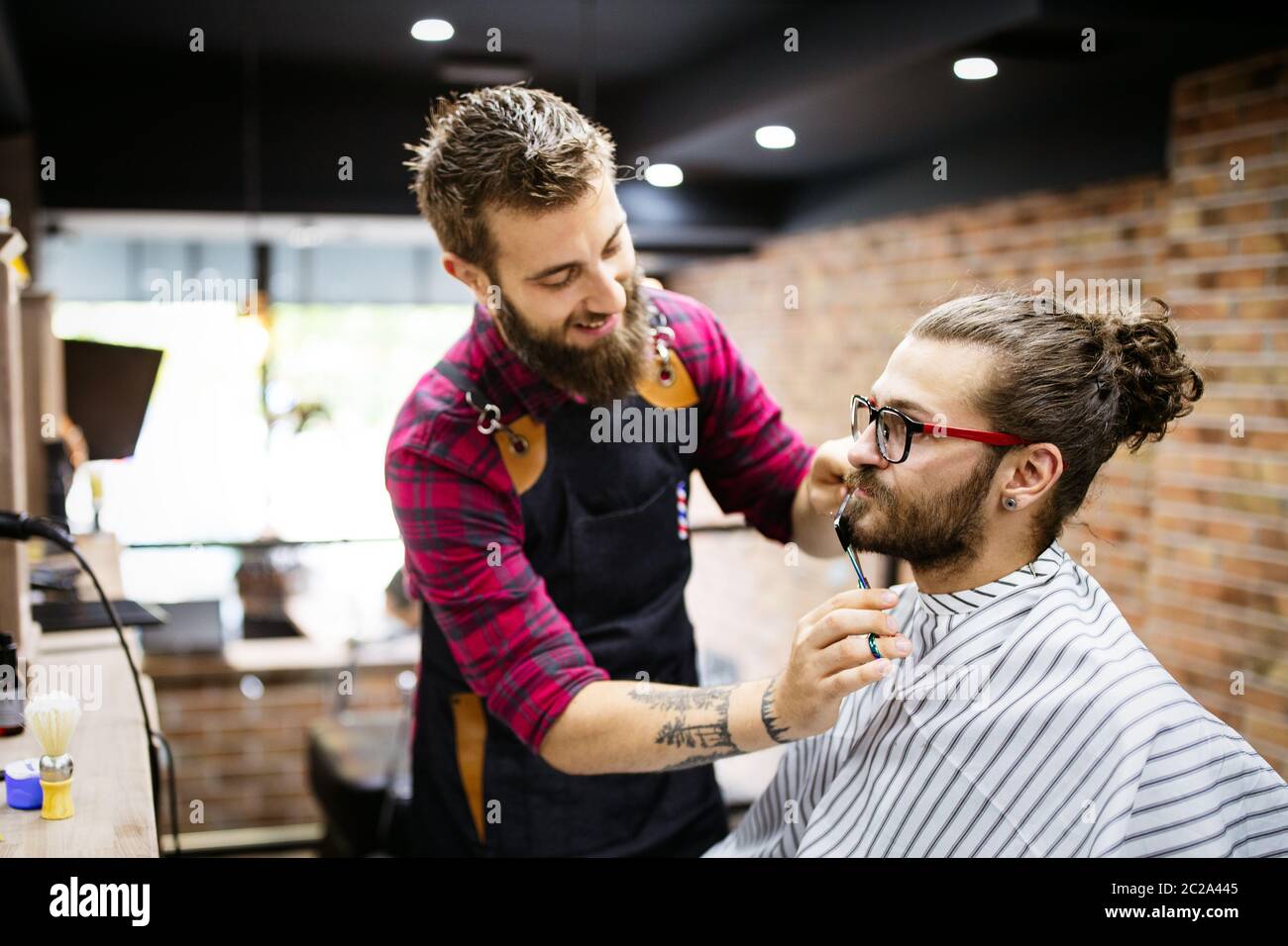 A man in the barber shop cutting his beard hi-res stock photography and ...