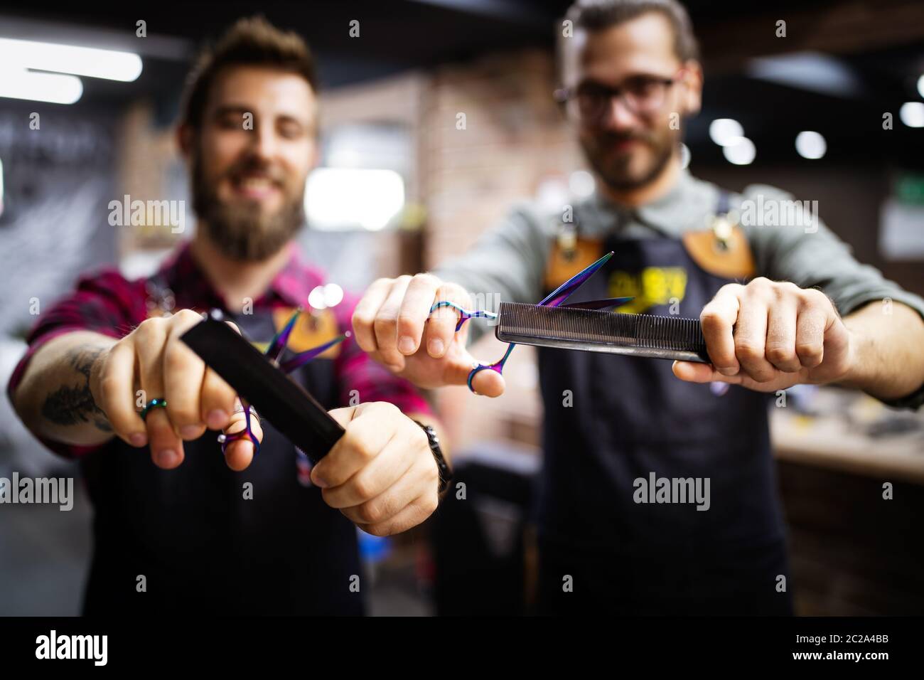 Portrait of young male barbers and hairdressers in barber shop Stock ...