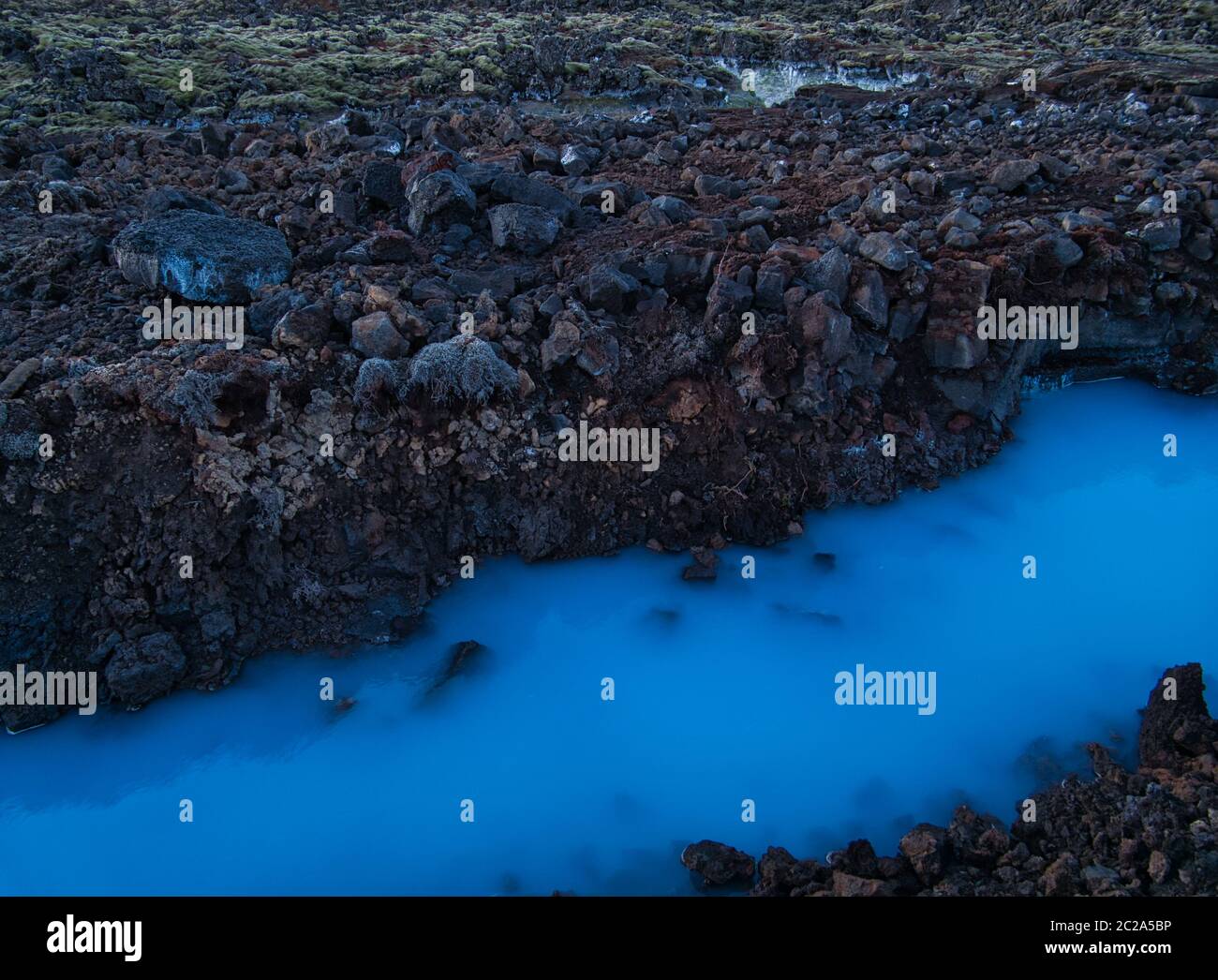 A lava landscape with the water of the Blue Lagoon in Iceland Stock ...