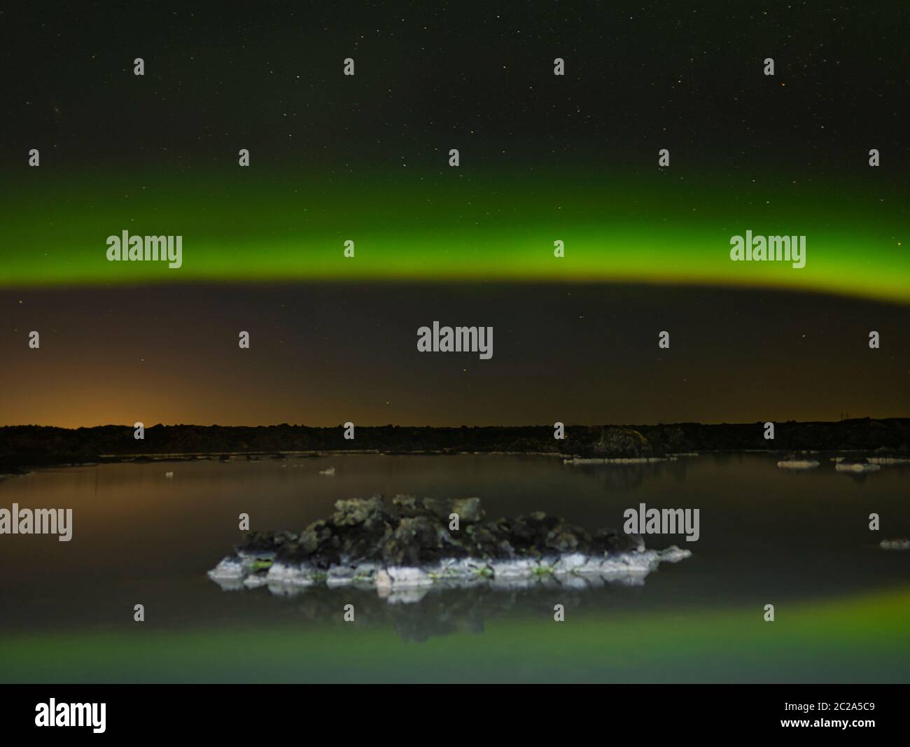 An Aurora Borealis arch over the Blue Lagoon in Iceland Stock Photo - Alamy