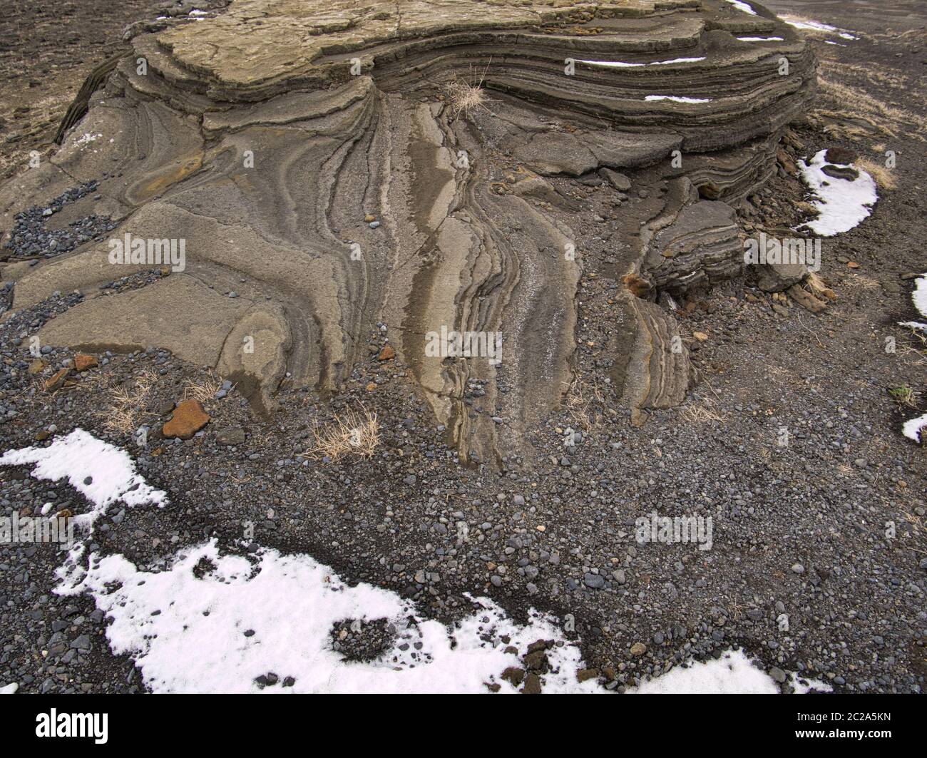 A rock formed by lava in Iceland with snow in March Stock Photo - Alamy