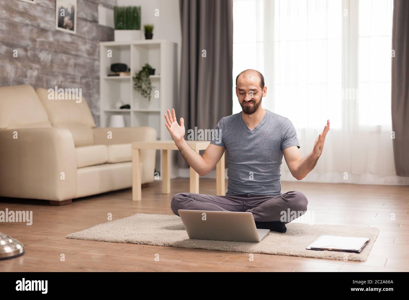 Excited man with hands raised in front of computer during quarantine ...