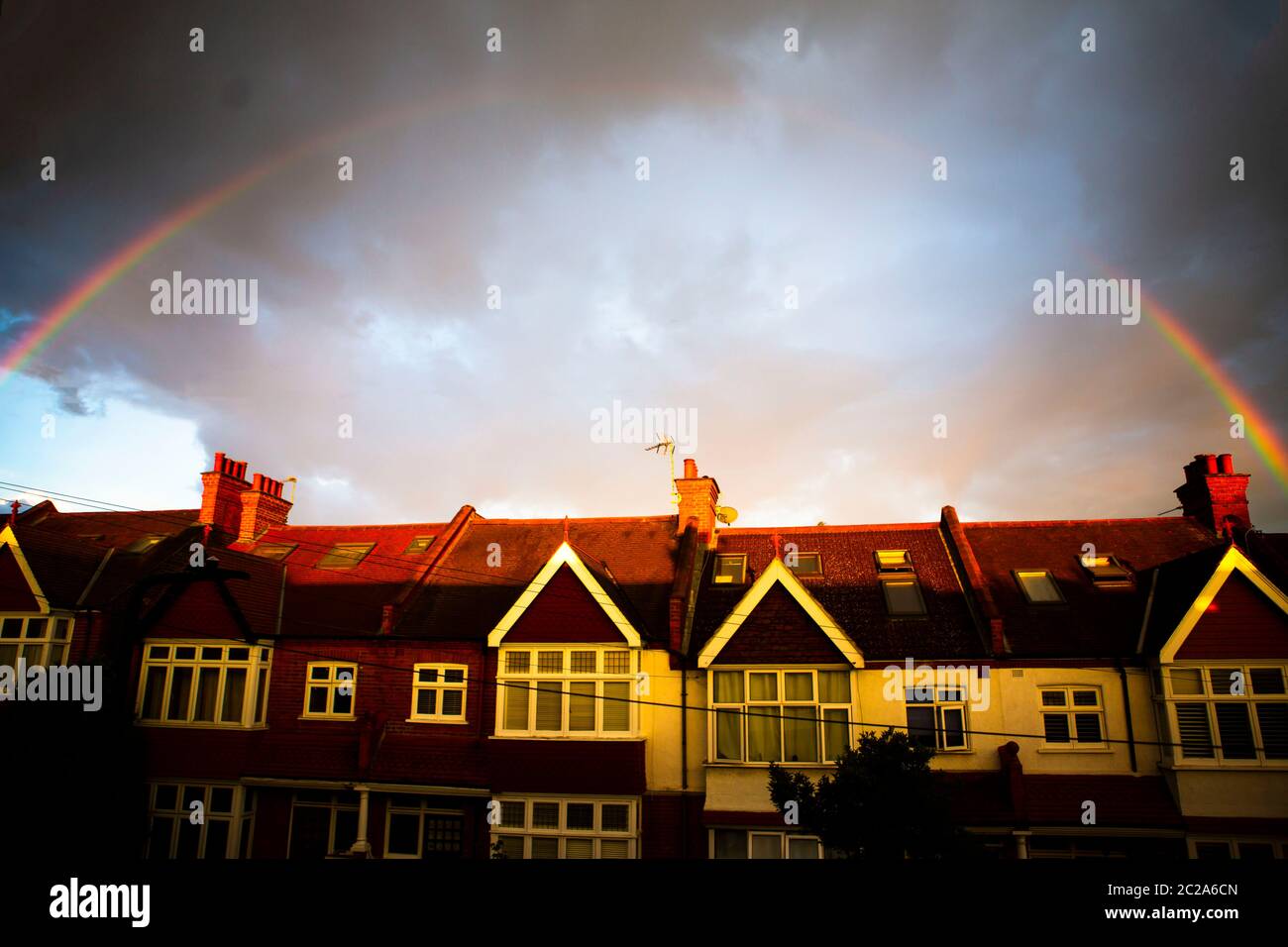Beautiful rainbow over roofs hi-res stock photography and images - Alamy