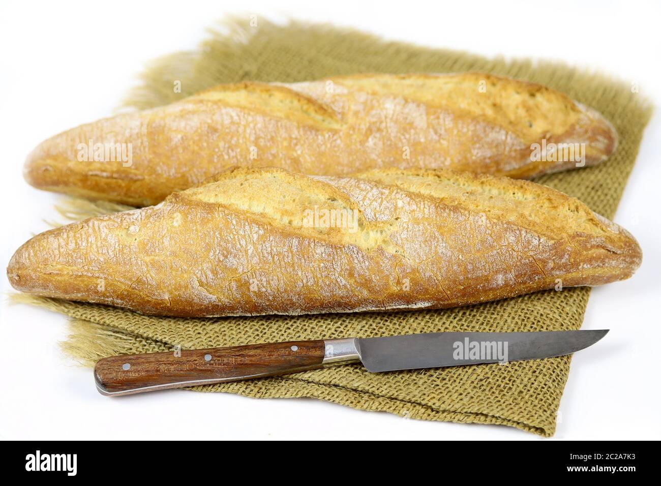 French bread sticks on a white background Stock Photo - Alamy