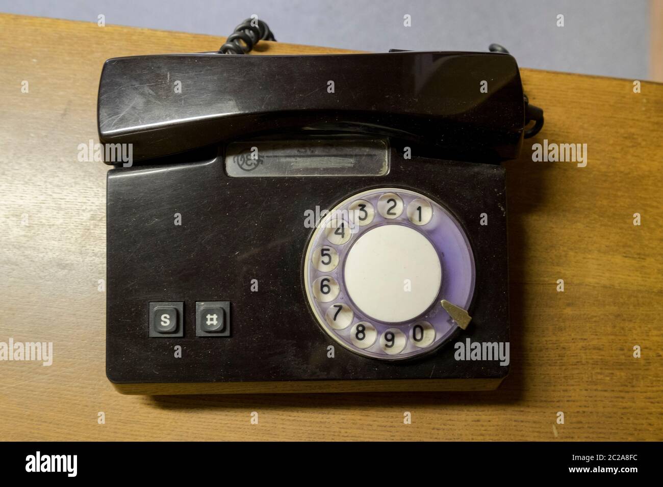A classic, old, black, rotary telephone in the office where seven ...