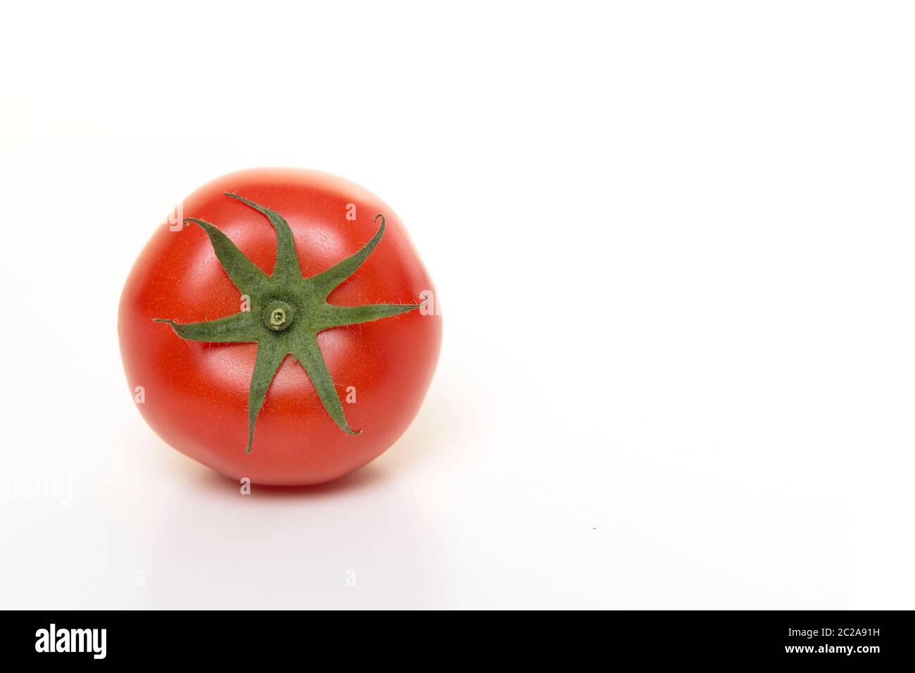 Single real tomatoe seen at its top isolated on a white background ...