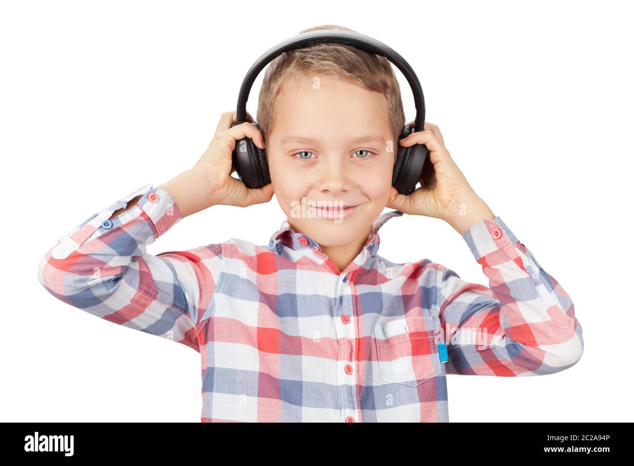Young boy listening to music with headphones. Isolated on white ...