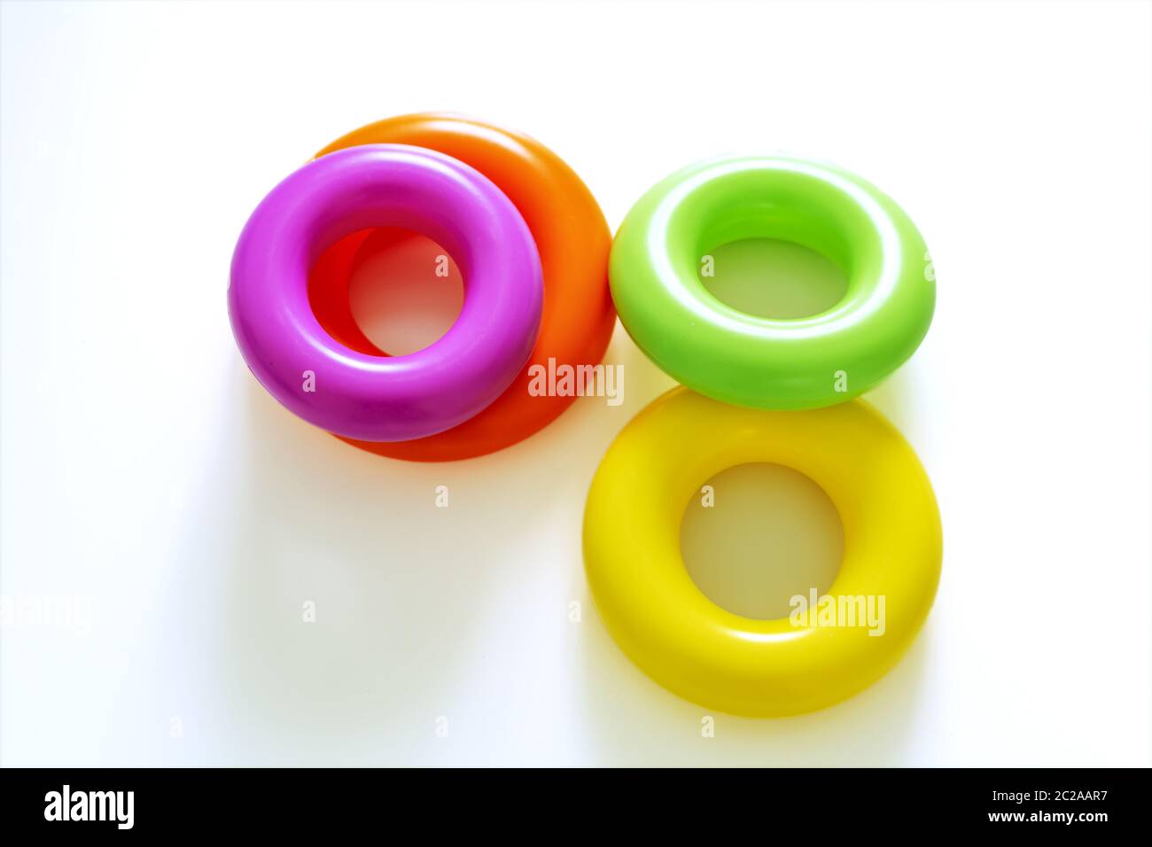 Colorful plastic rings on a white background to be stacked in a tower ...