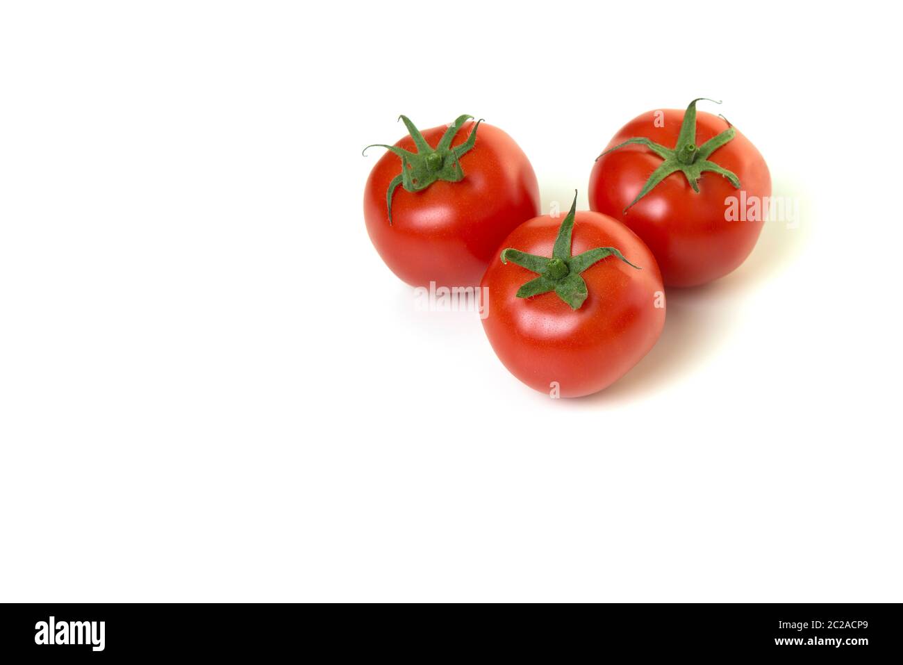 Three real tomatoes in a triangle seen from a high angle view on a ...