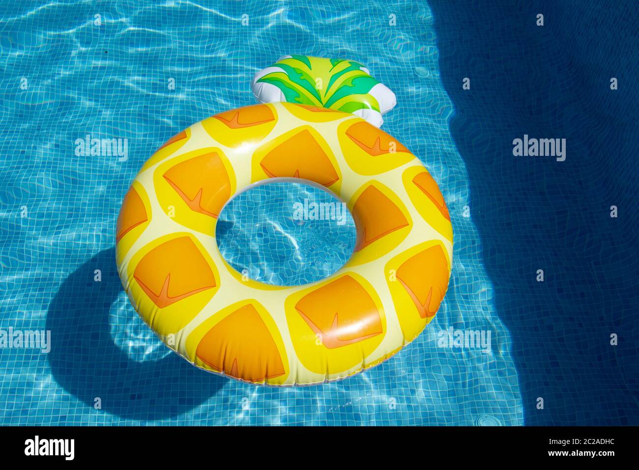 inflatable pineapple ring floating in swimming pool Stock Photo - Alamy