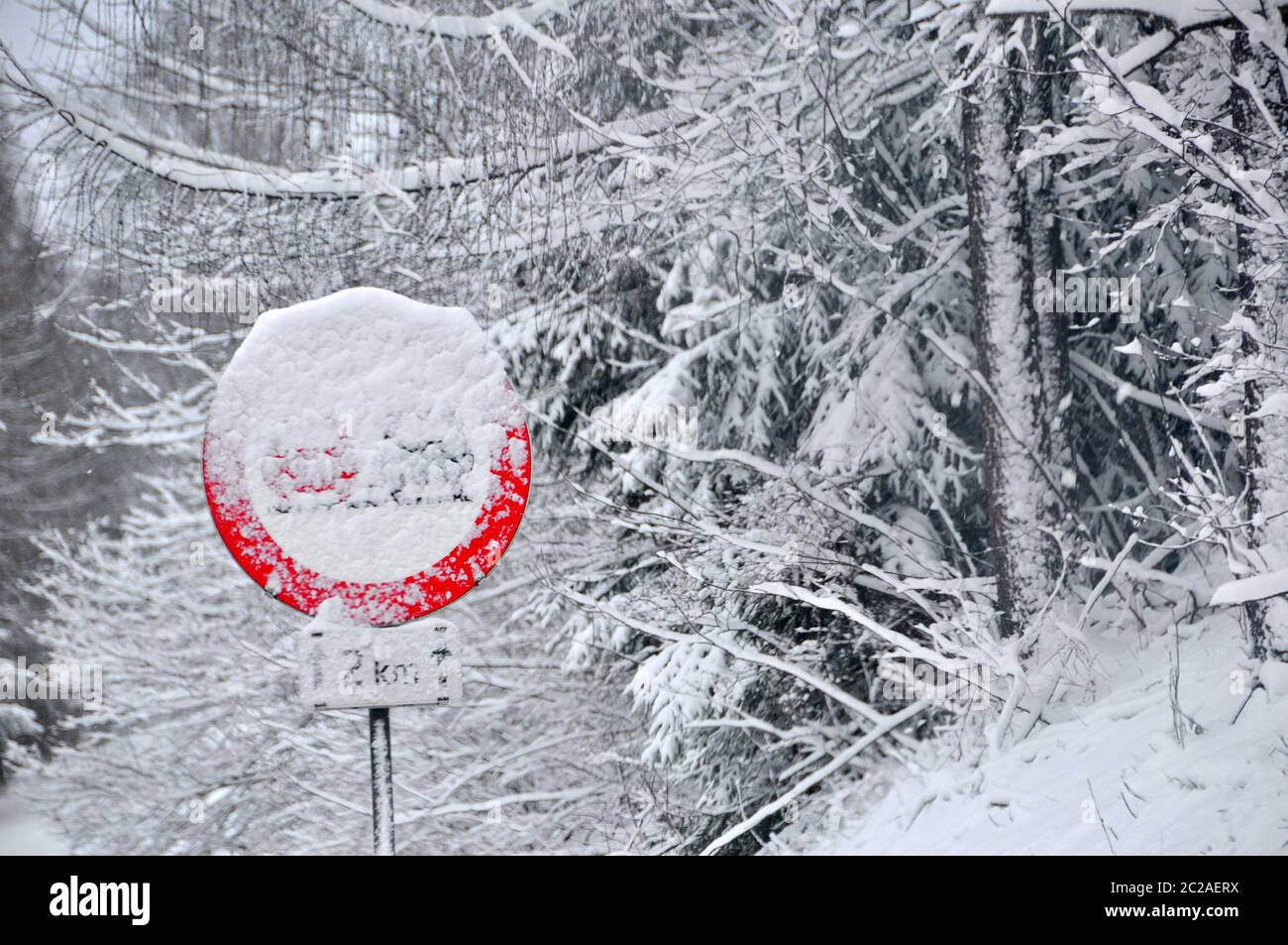 Winter road with snowy road sign in Austria Stock Photo - Alamy