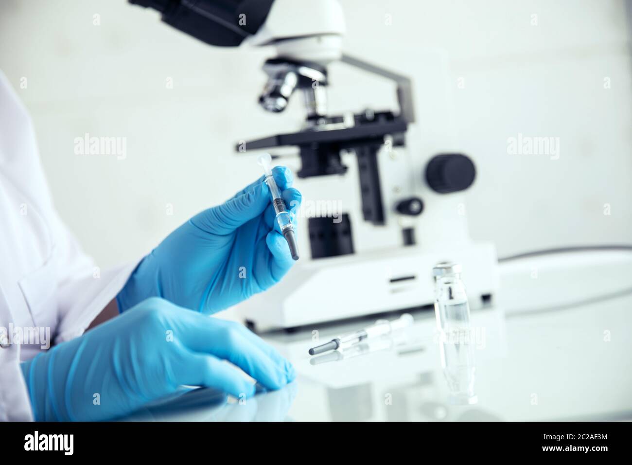 Hands holds a syringe. Hands in medical gloves holds a syringe with ...