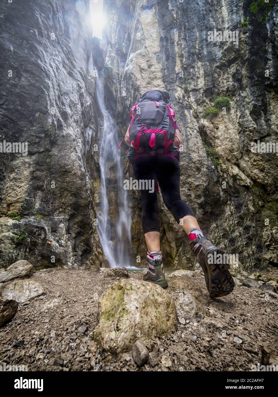Hiker girl under a waterfall in the Italian alps Stock Photo - Alamy